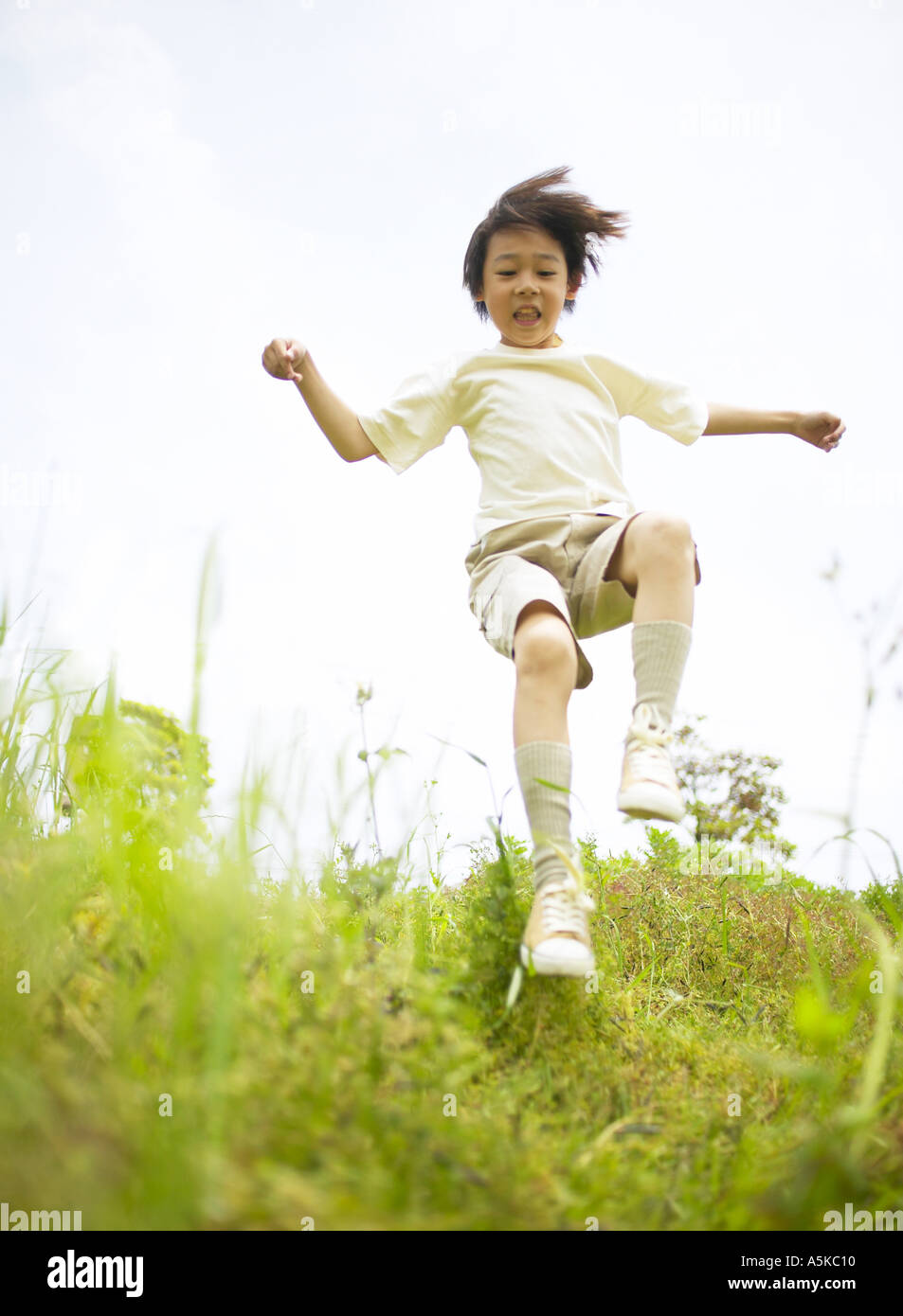 Young boy jumping Stock Photo - Alamy