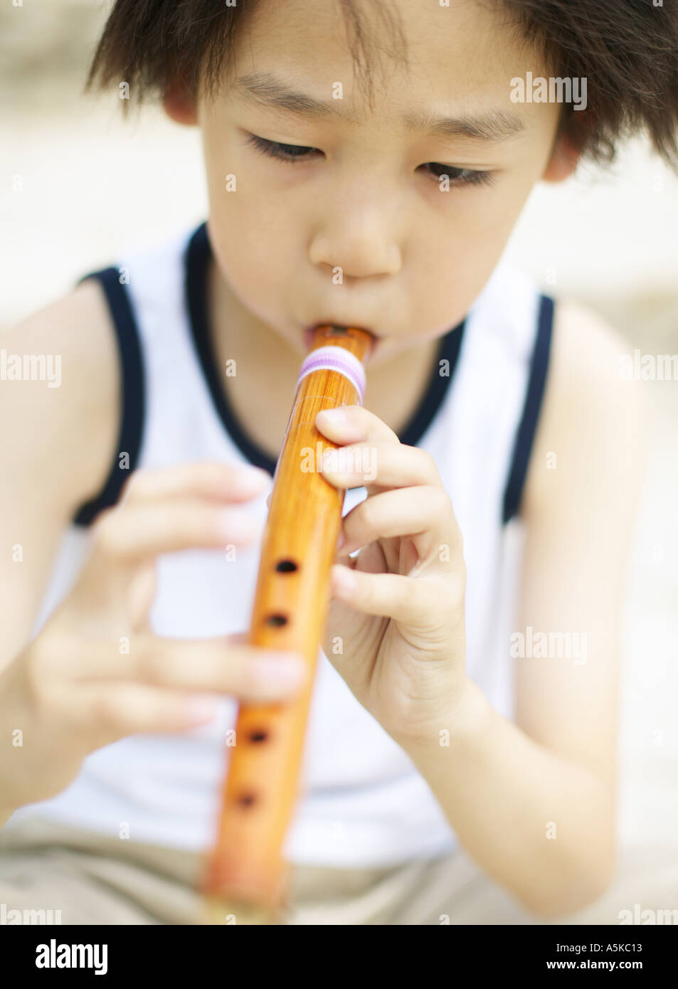 Young boy playing flute Stock Photo - Alamy