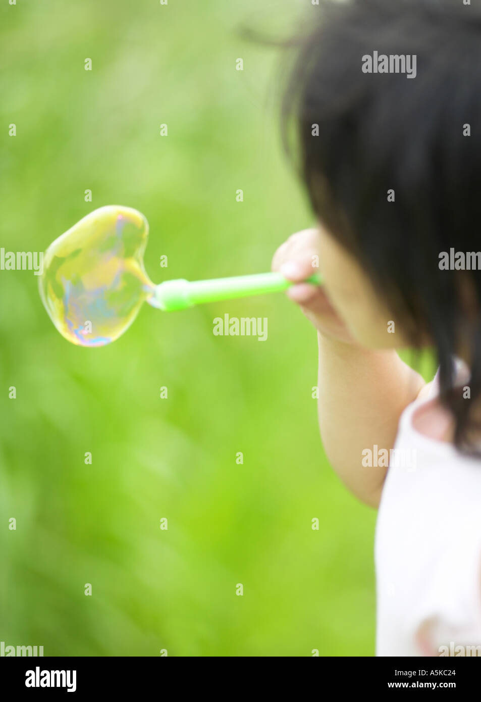 Child blowing bubbles Stock Photo - Alamy