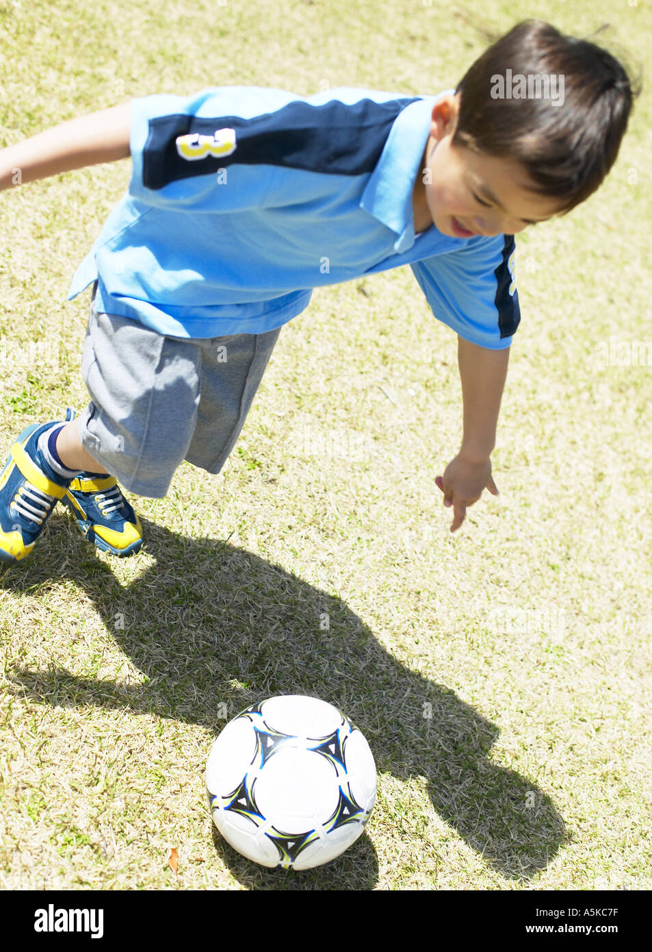 Young boy playing football Stock Photo - Alamy Young boy playing football Stock Photo - Alamy