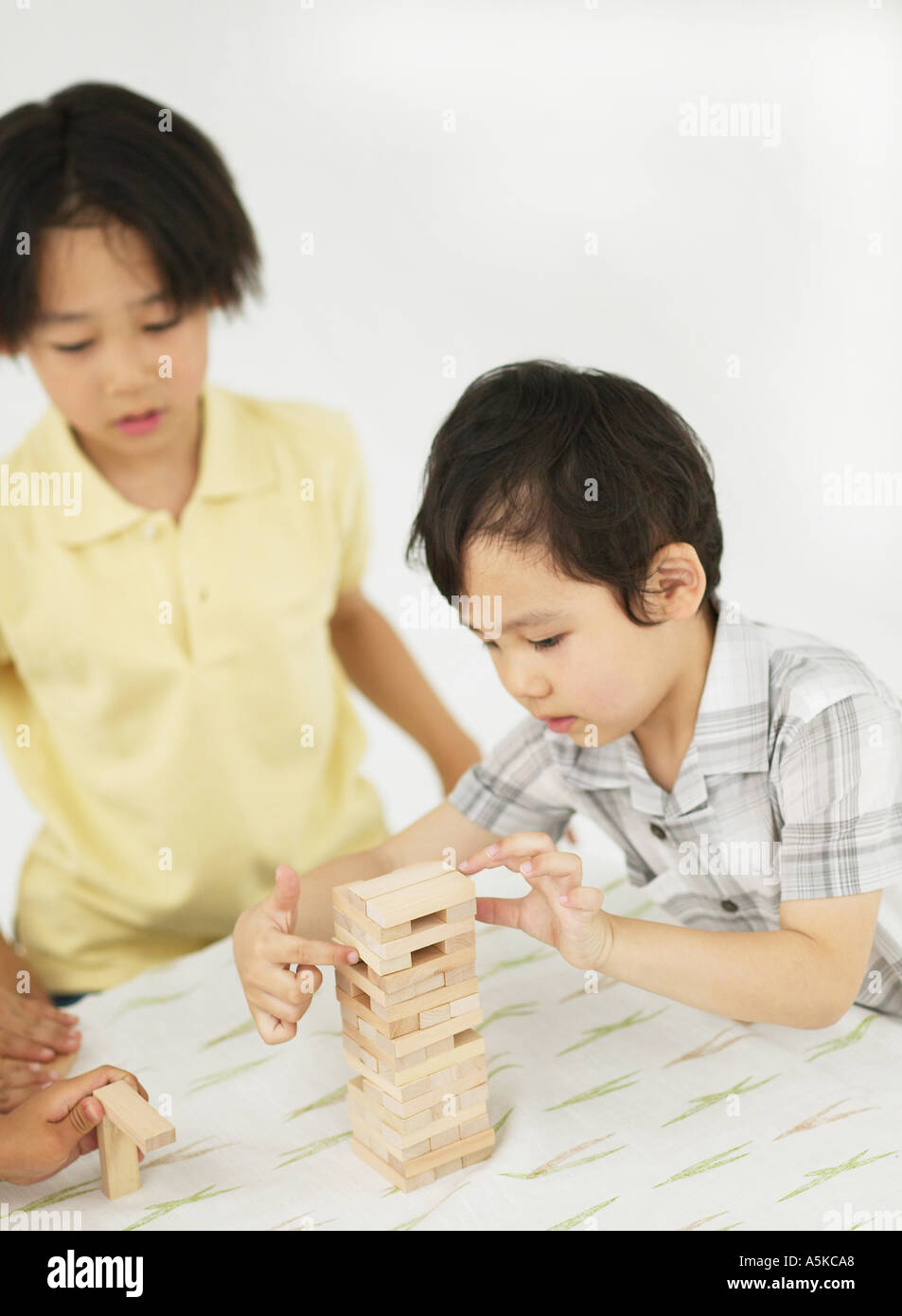 Young children playing with wooden building blocks Stock Photo - Alamy