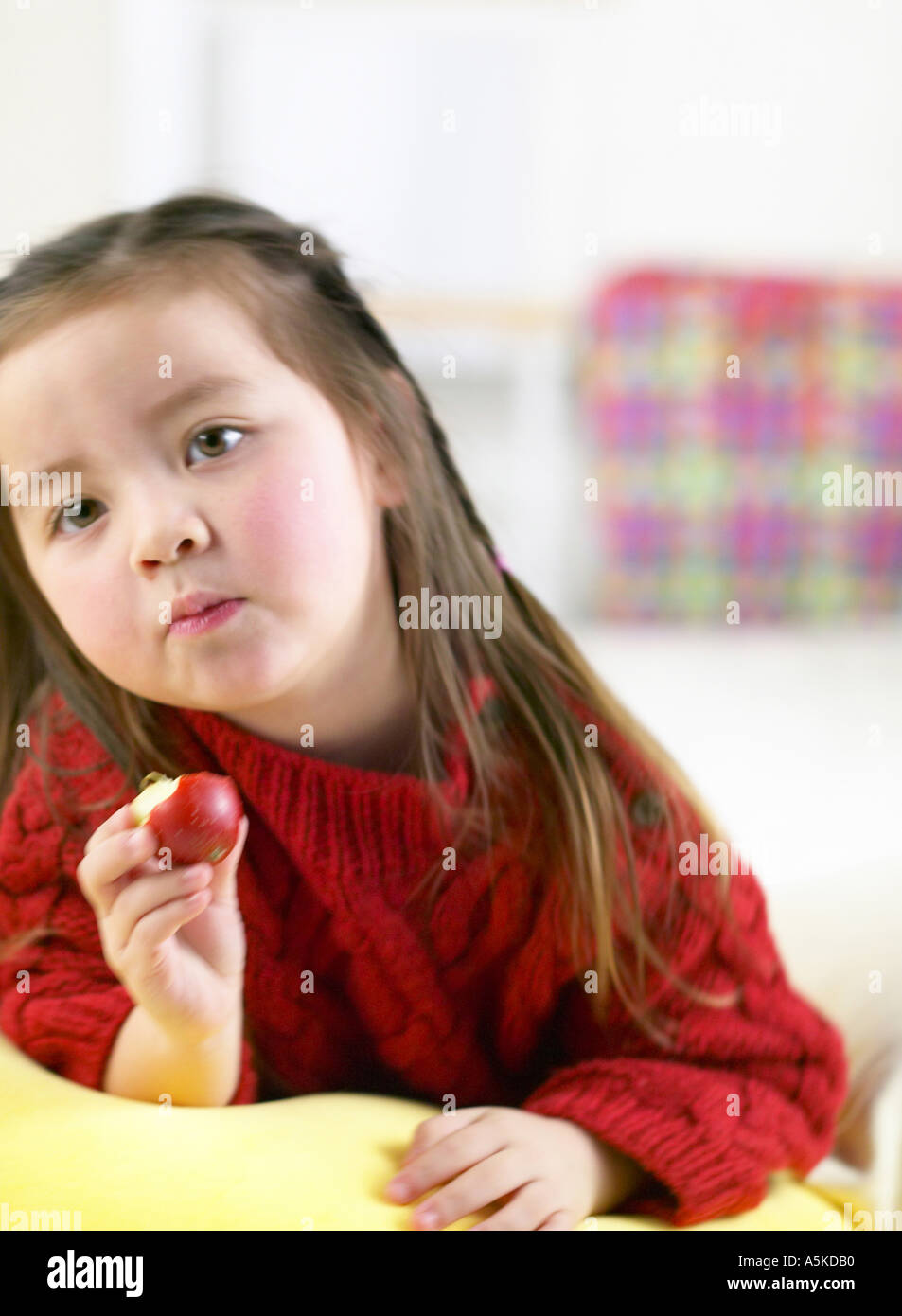 Young girl eating fruit Stock Photo - Alamy