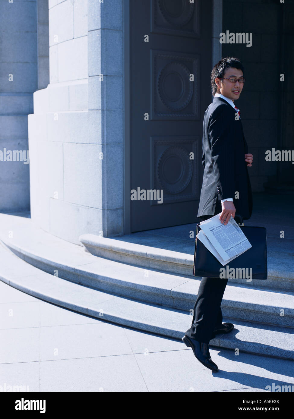 Successful businessman entering building hi-res stock photography and ...