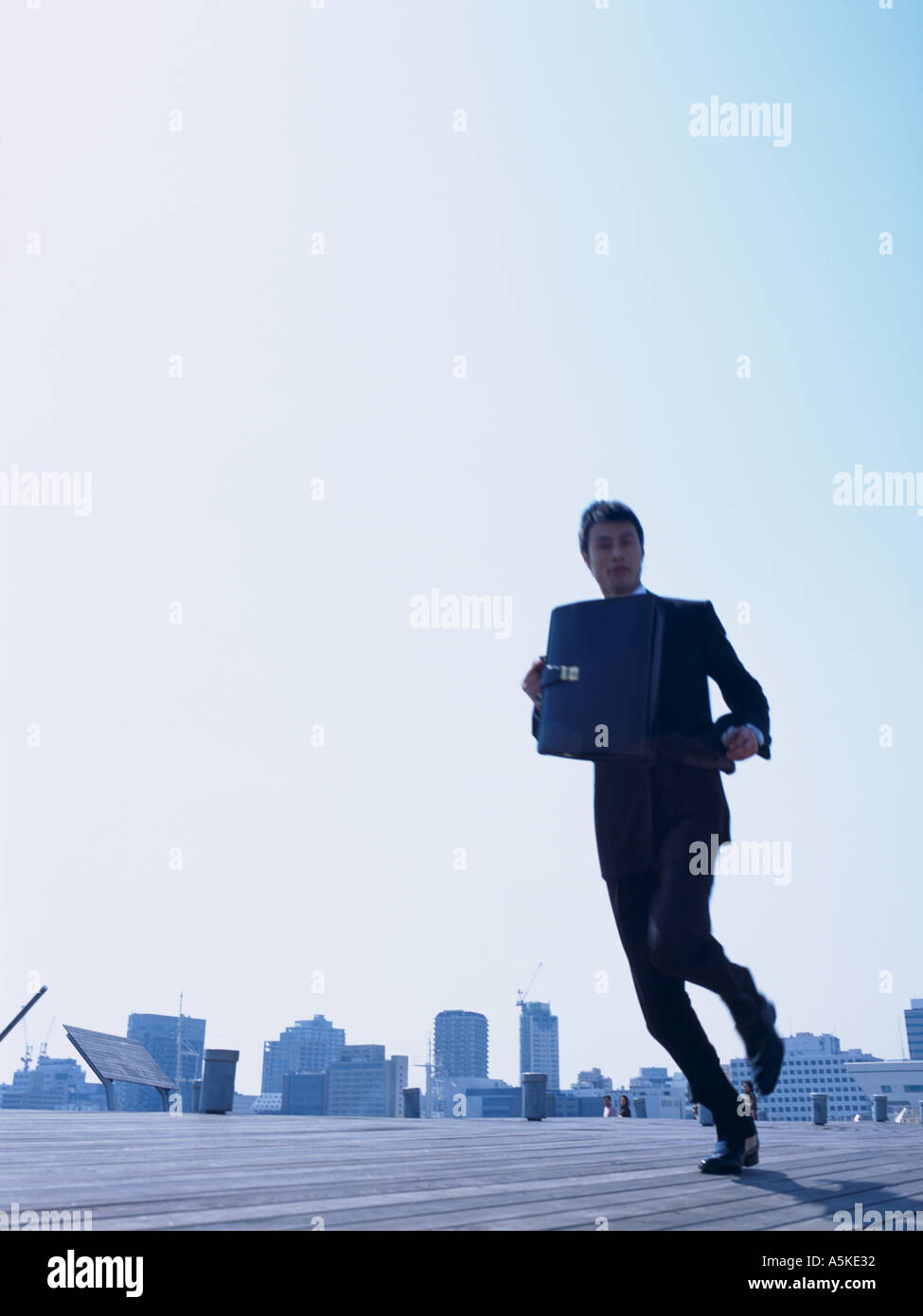 Asian Man running on a walkway Stock Photo - Alamy