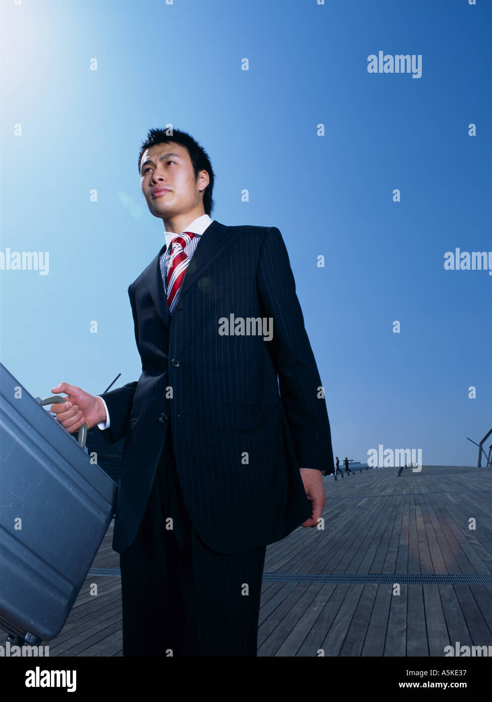 Asian Man walking on a walkway Stock Photo - Alamy