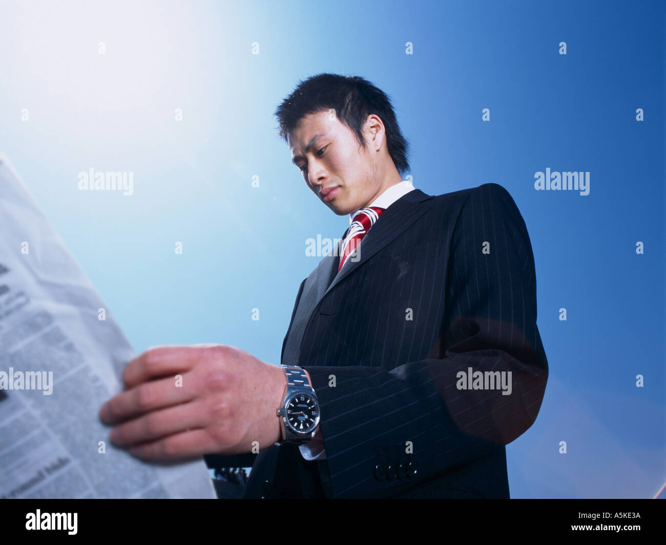 Asian man reading newspaper hi-res stock photography and images - Alamy