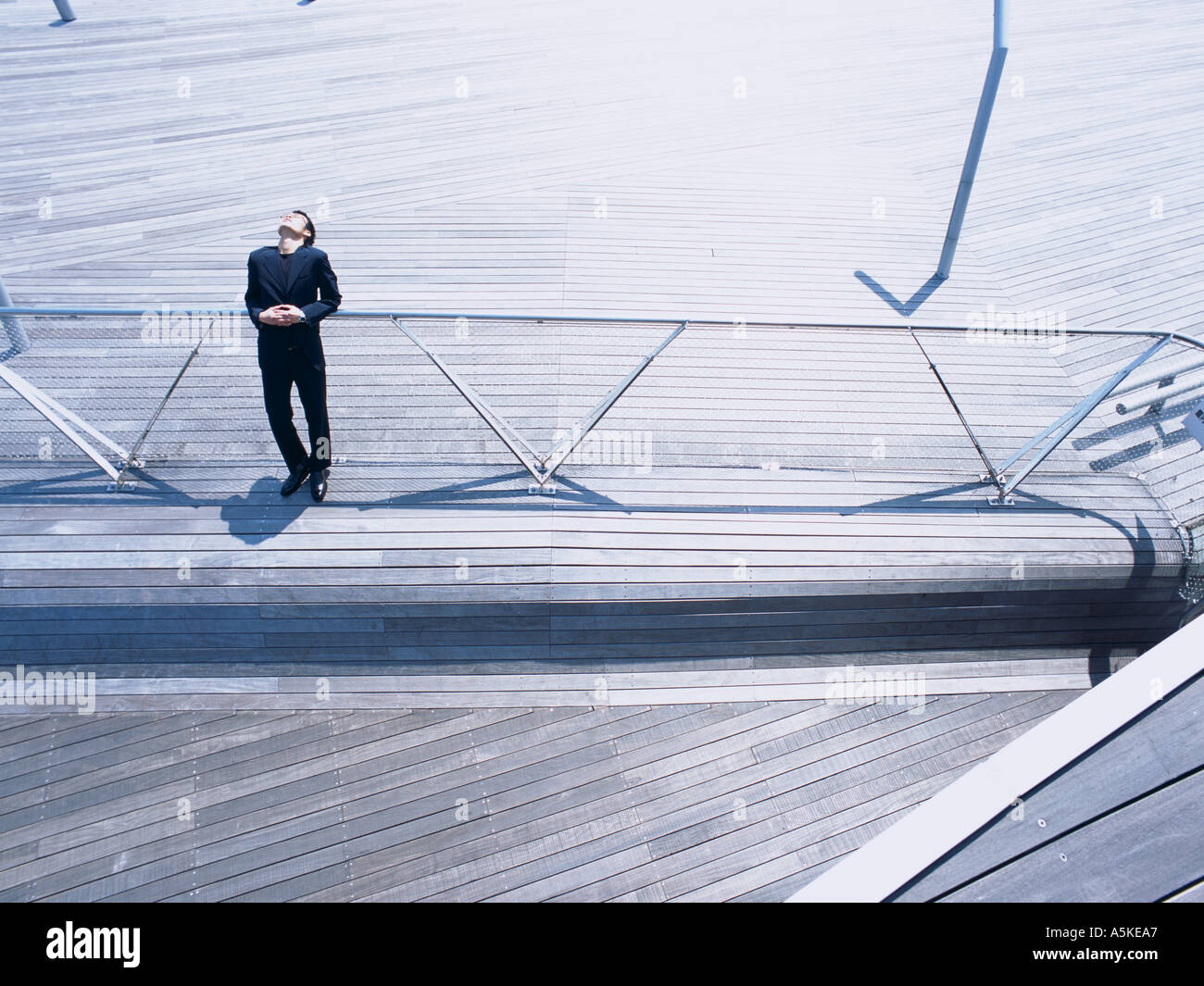 Aerial view of a man leaning over a railing Stock Photo - Alamy
