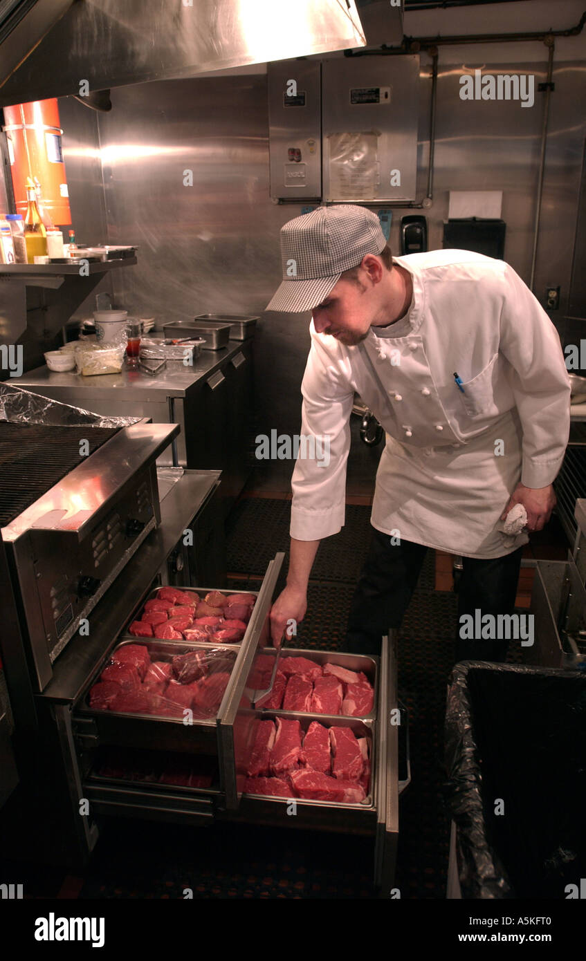 A Chef looks over a slection of Steaks in a drawer underneath the ...