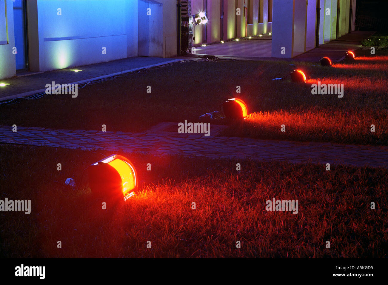 five colourful yellow spotlight on lawn Stock Photo - Alamy