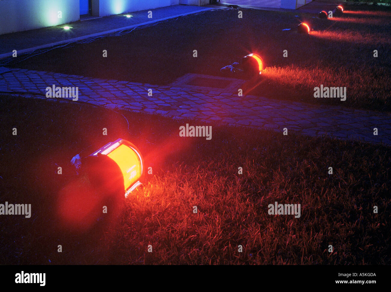 three colourful yellow spotlight on lawn Stock Photo - Alamy