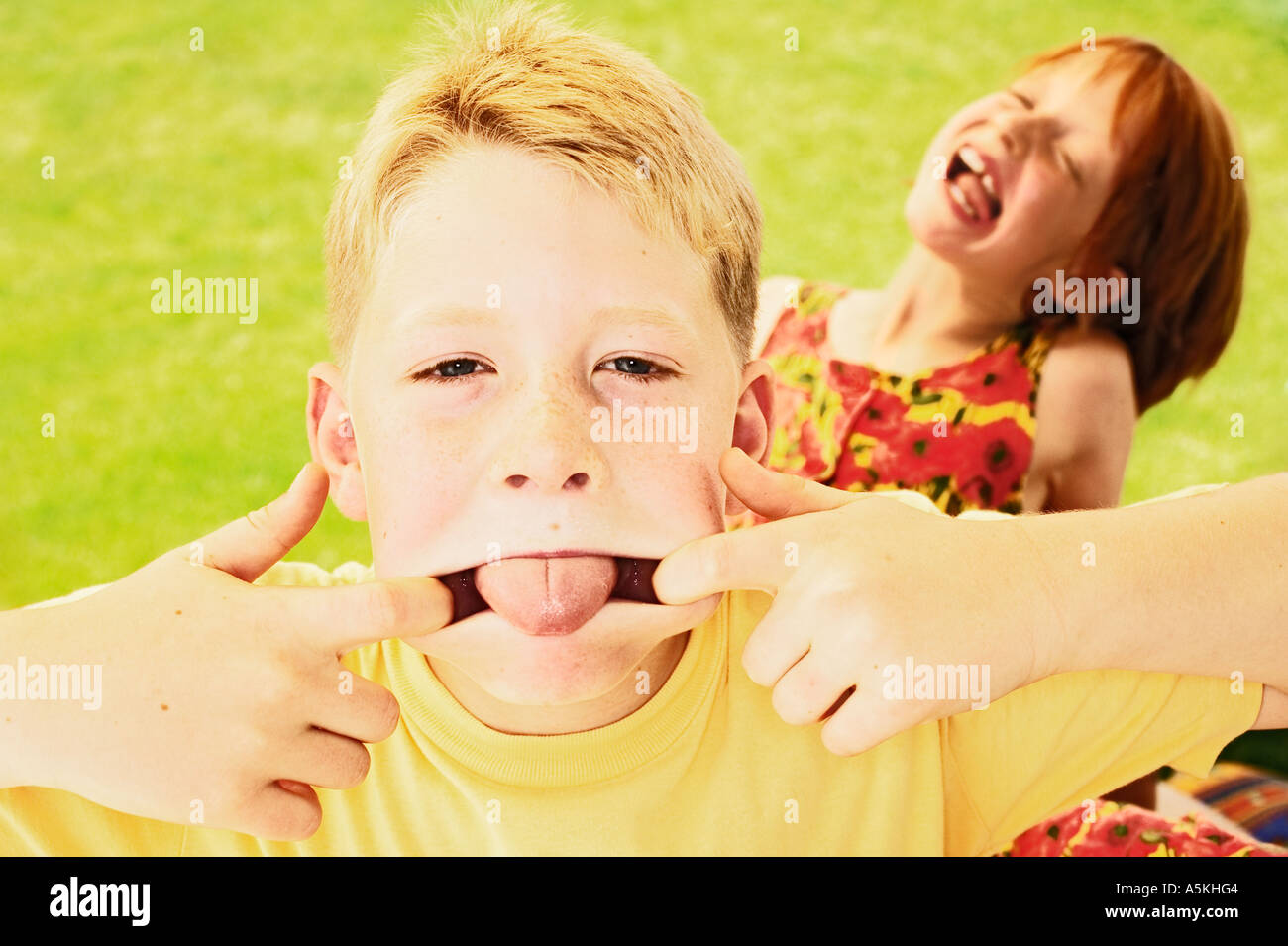 Two Kids Pulling Faces Stock Photo - Alamy