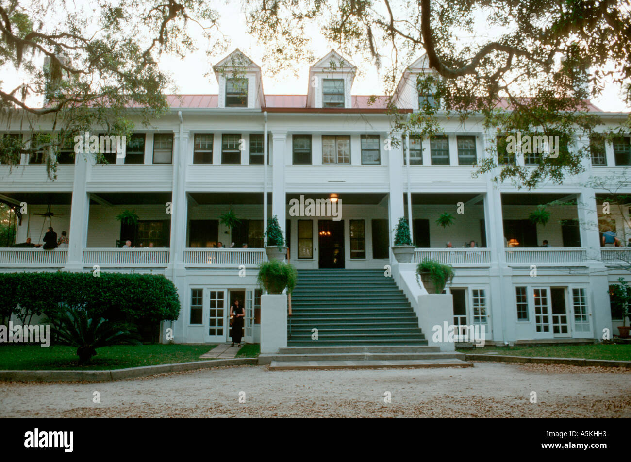 The Greyfield Inn facade is seen through the sprawling branches of the ...