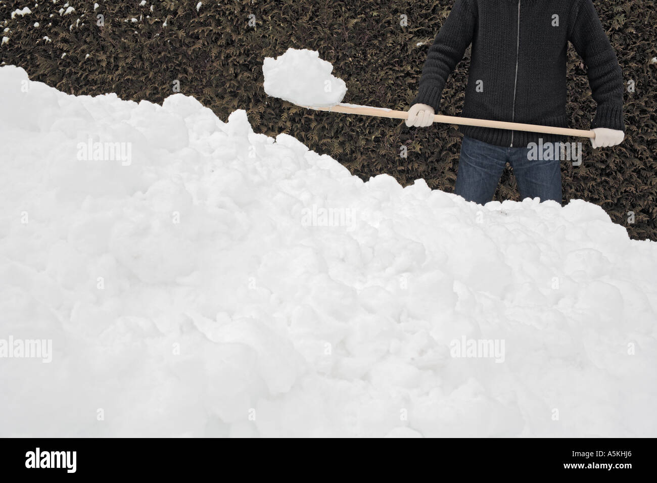 Young man shoveling snow hi-res stock photography and images - Alamy