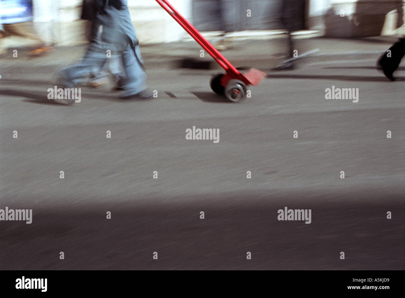 man pushing empty goods trolley on road Stock Photo - Alamy