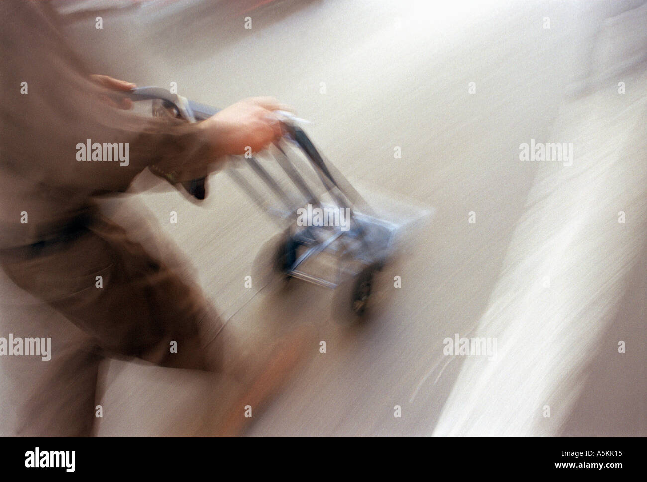man pushing empty goods trolley on road blur Stock Photo - Alamy
