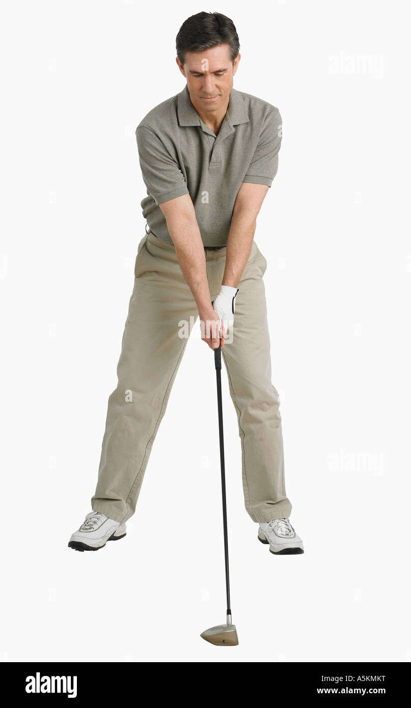 Studio shot of man playing golf Stock Photo - Alamy