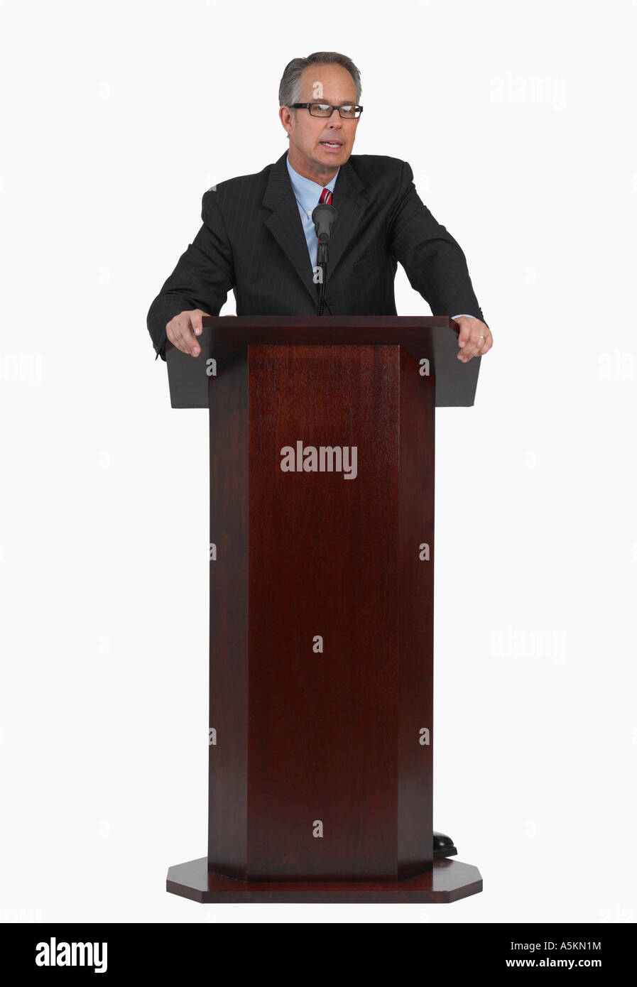 Businessman speaking at podium Stock Photo - Alamy