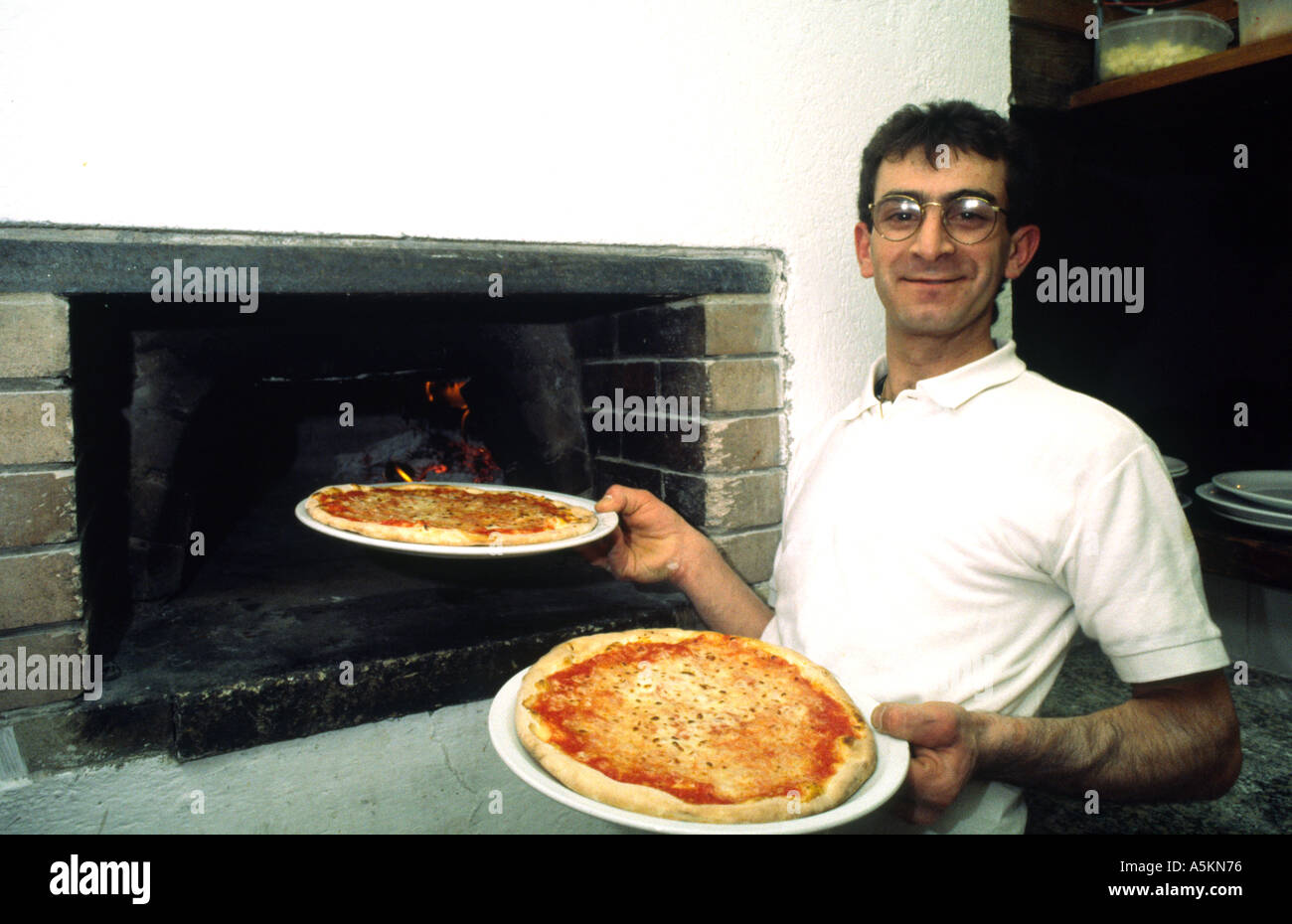 Italian Pizza chef at his wood fired oven Stock Photo - Alamy