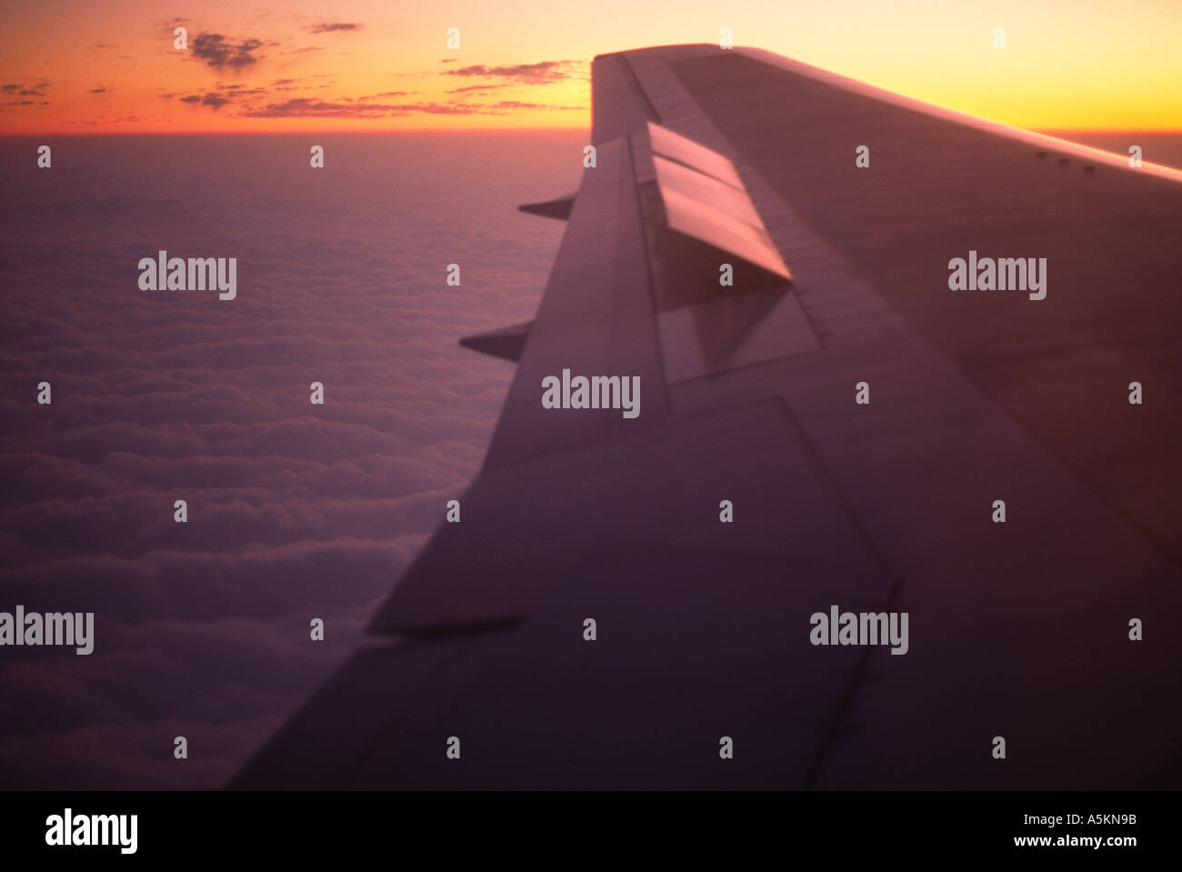 Dawn breaks over a plane wing in flight Stock Photo - Alamy