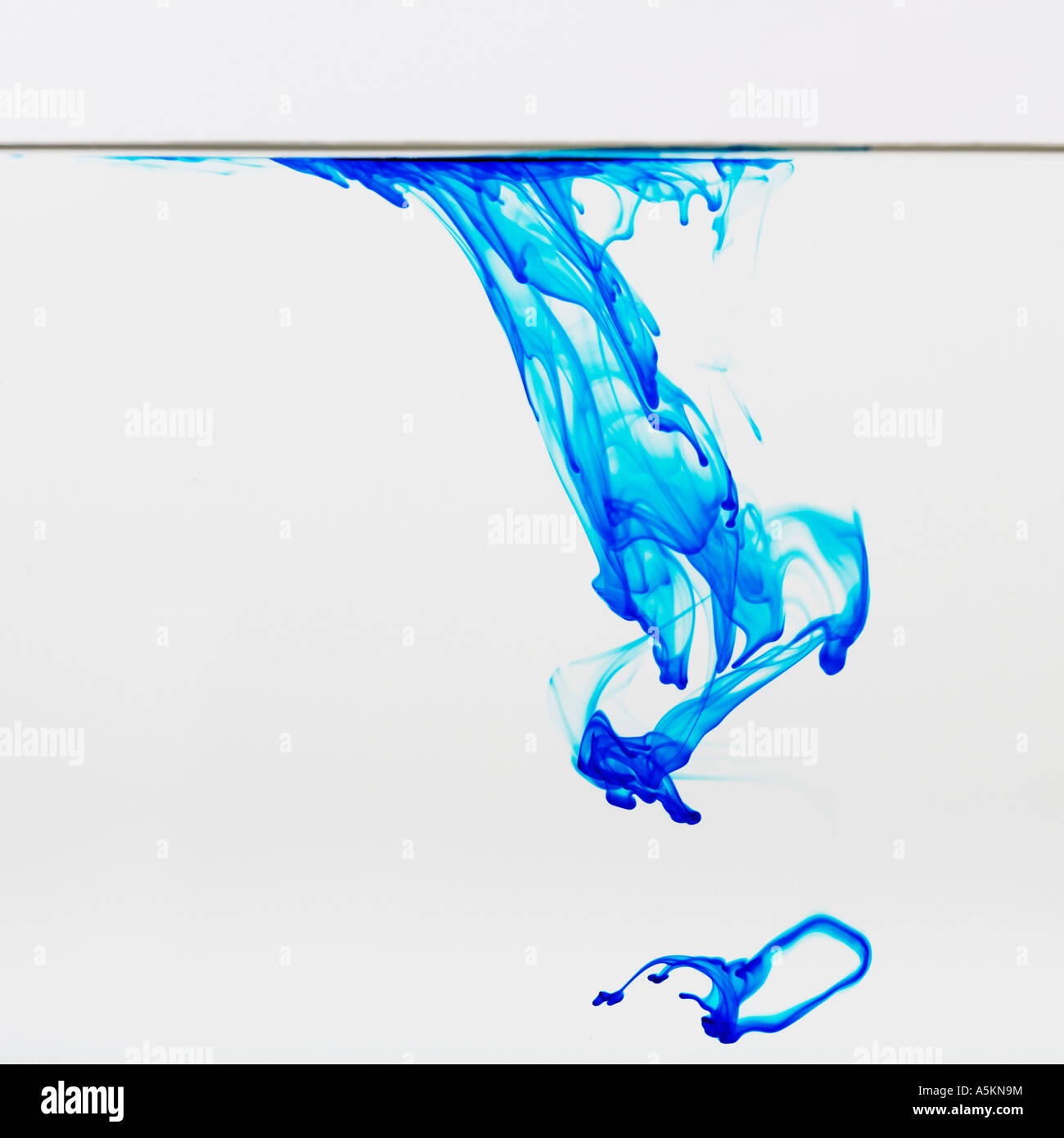 Blue dye floating in water Stock Photo - Alamy