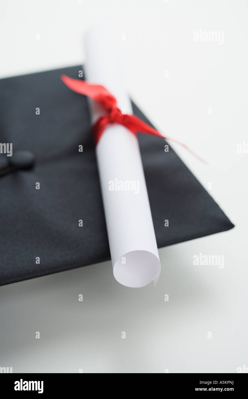 Close up of diploma and graduation cap Stock Photo - Alamy