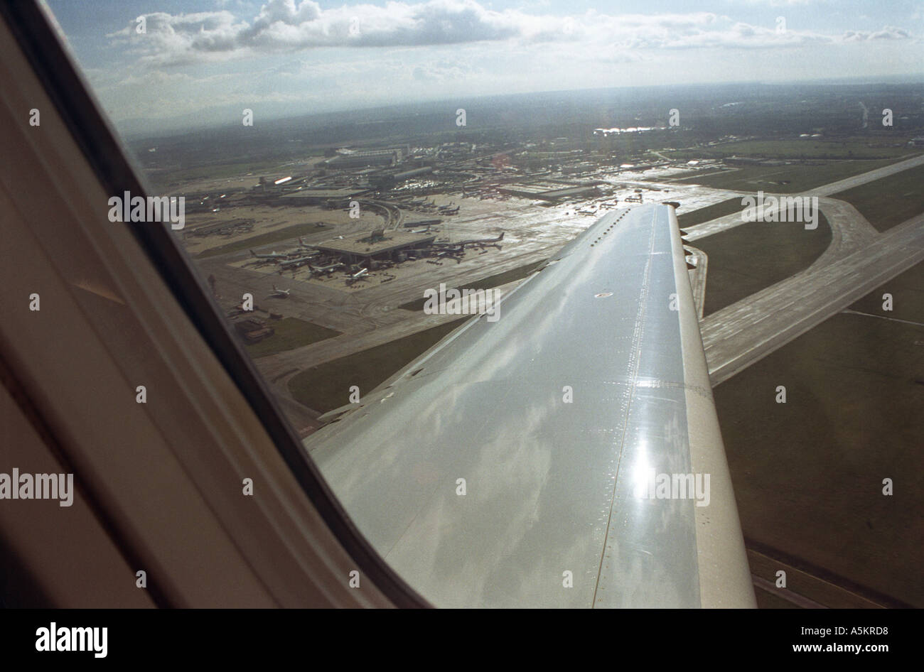 view of wing and airport from airborne plane Stock Photo - Alamy