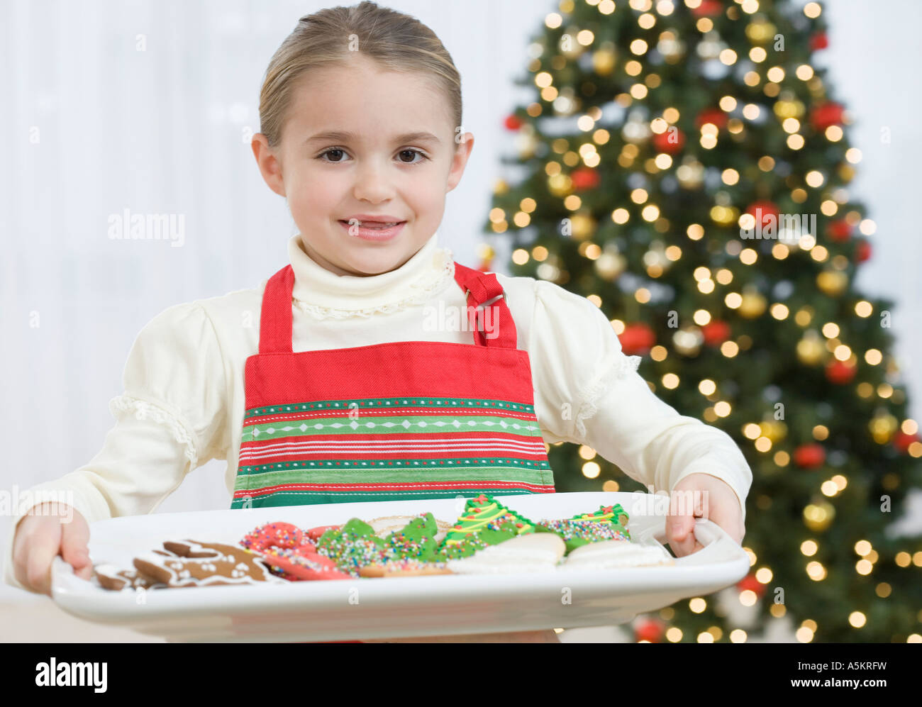 Girl carrying tray of Christmas cookies Stock Photo - Alamy