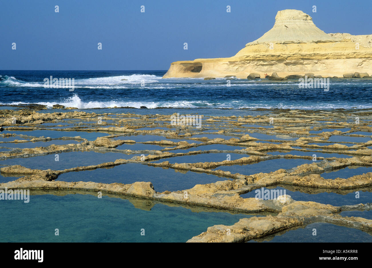Rocky coast with evaporation basins at Xwieni Bay, Gozo island, Malta ...