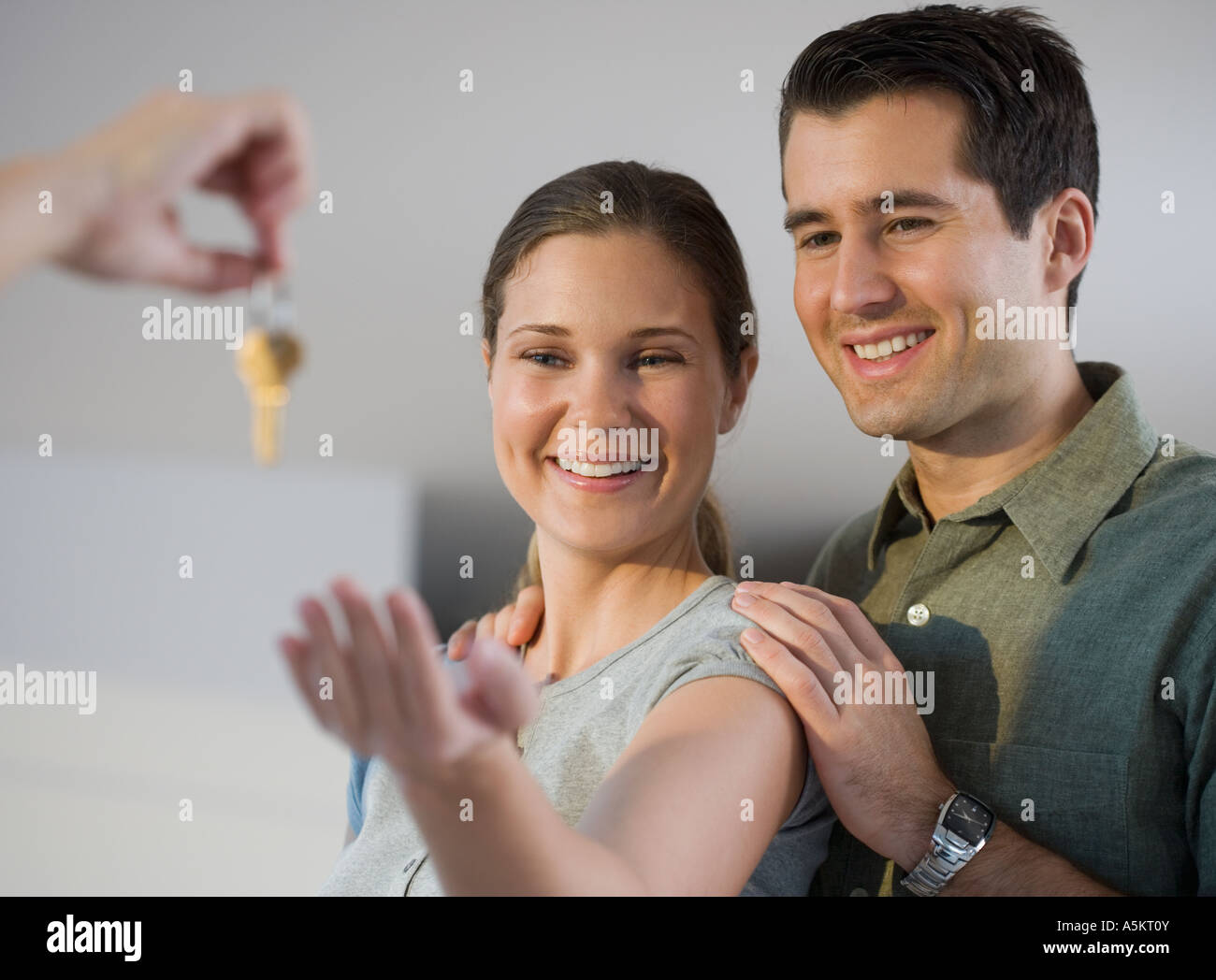 Portrait of couple receiving keys Stock Photo - Alamy
