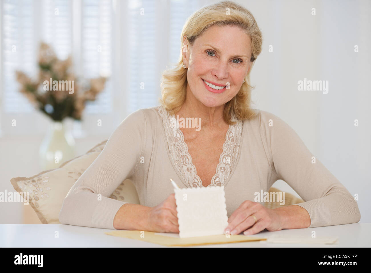 Senior woman writing card Stock Photo - Alamy