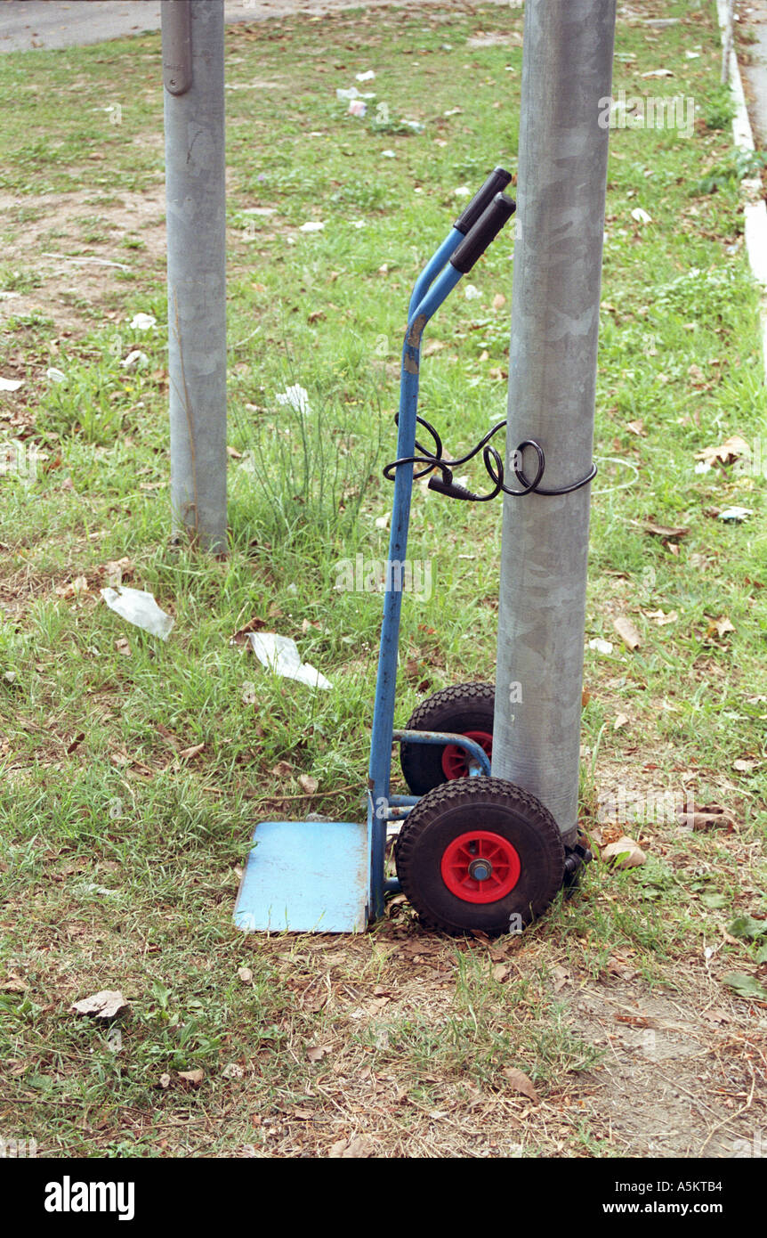 goods trolley locked to a lamp post Stock Photo - Alamy