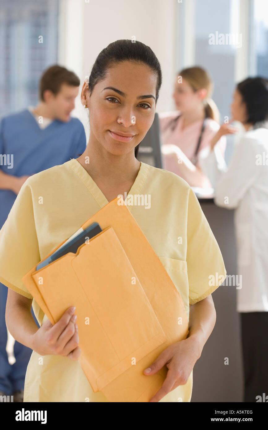 Portrait of female doctor holding files Stock Photo - Alamy