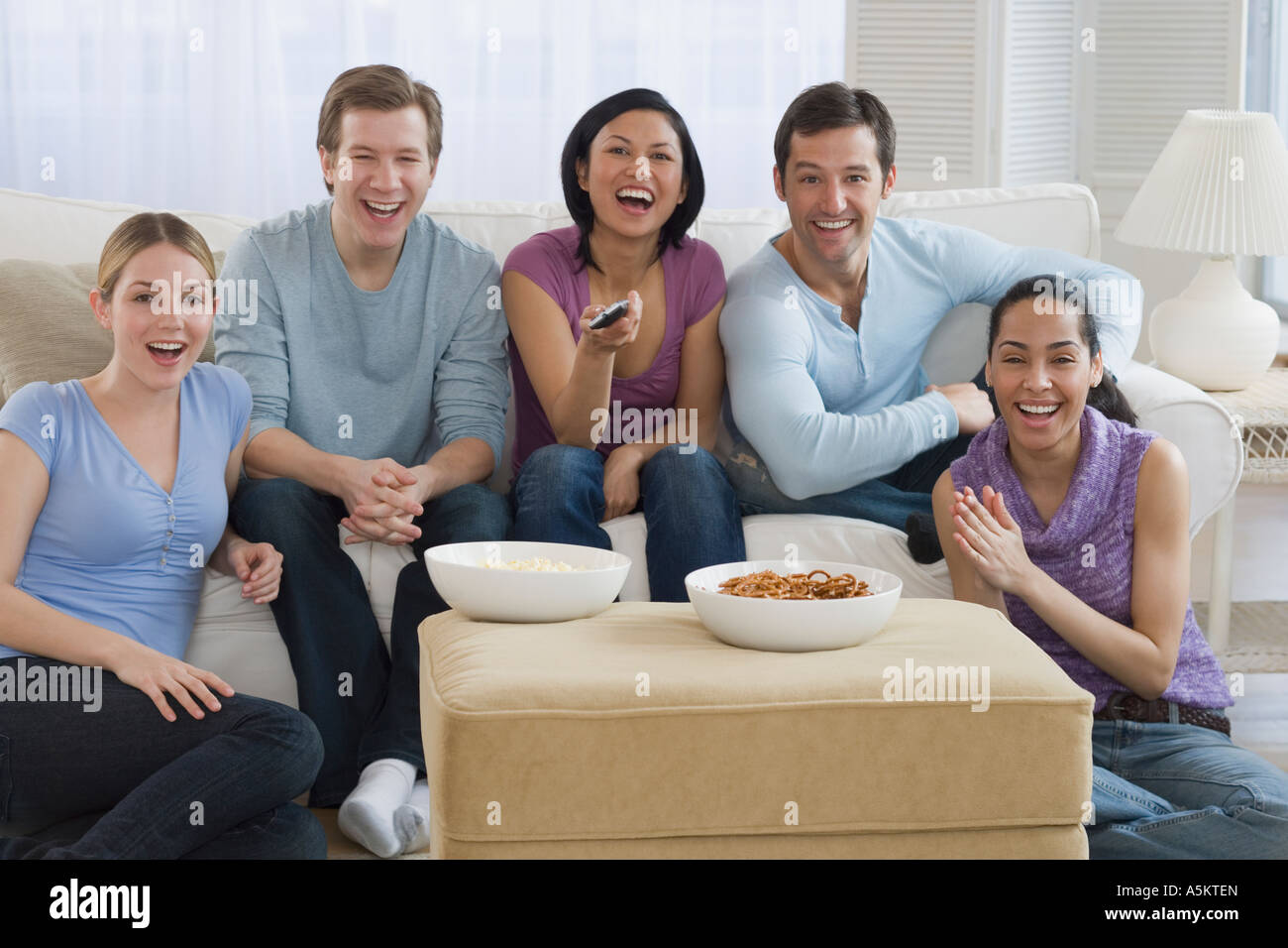 Group of friends watching television Stock Photo - Alamy
