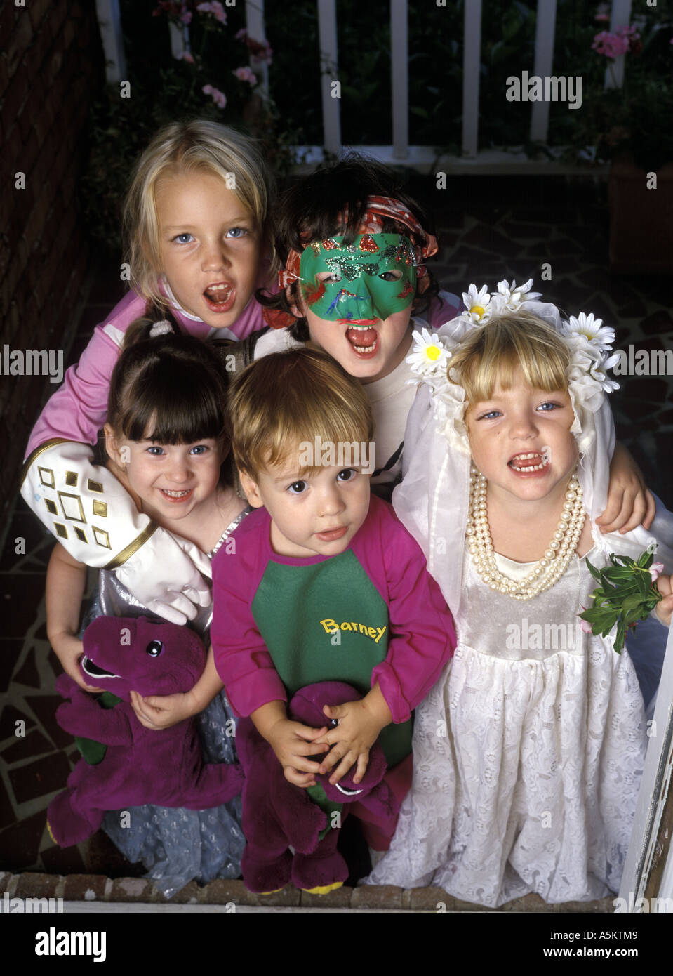 Five children are dressed up in costumes as they trick or treat at the ...