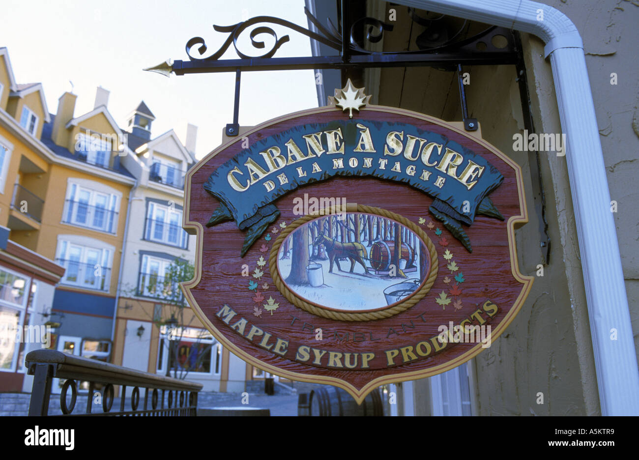 A colorful sign for maple syrup hangs on the building of a store in the ...