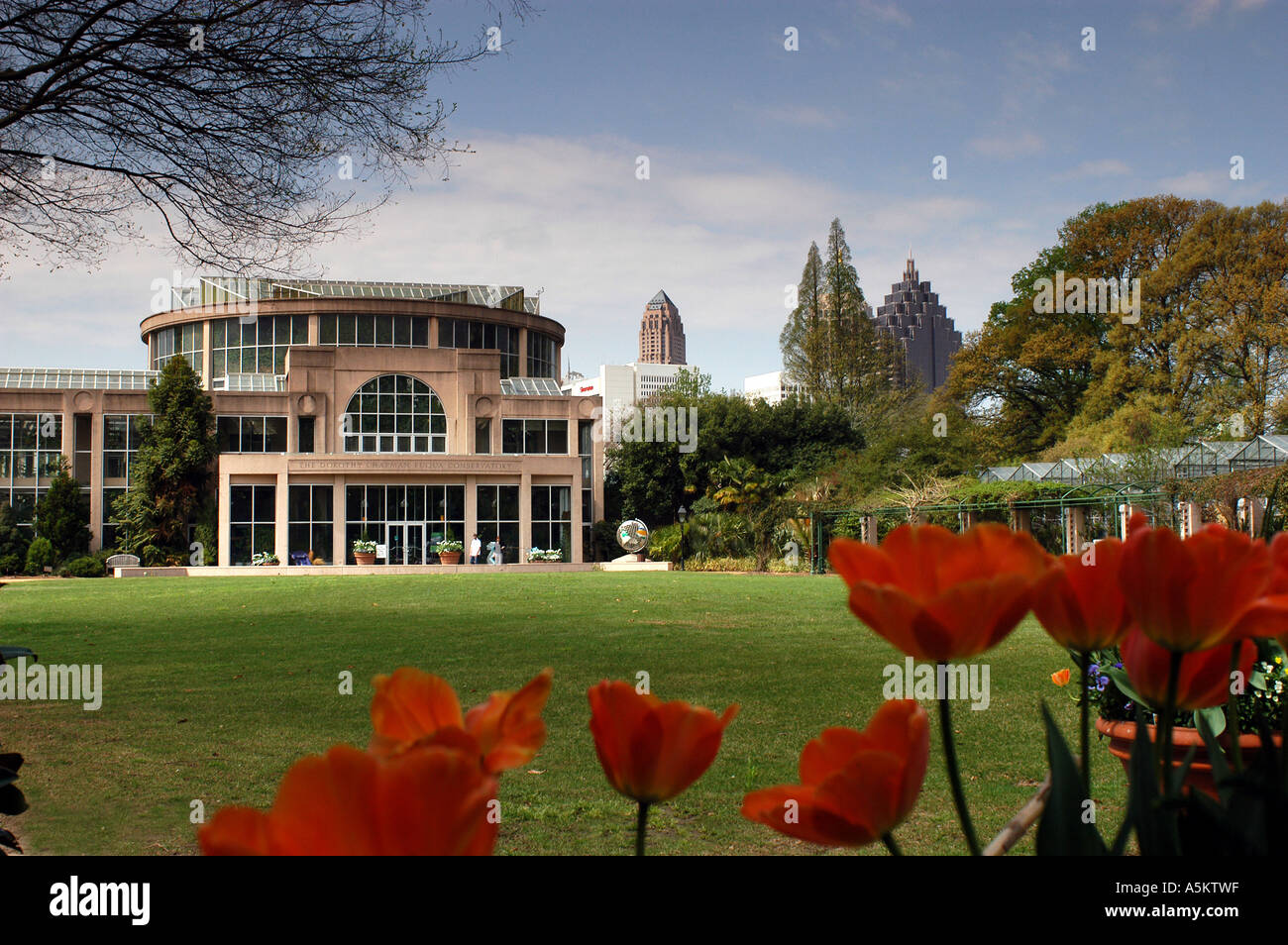 The Fuqua conservatory is seen against a beautiful blue sky with red ...