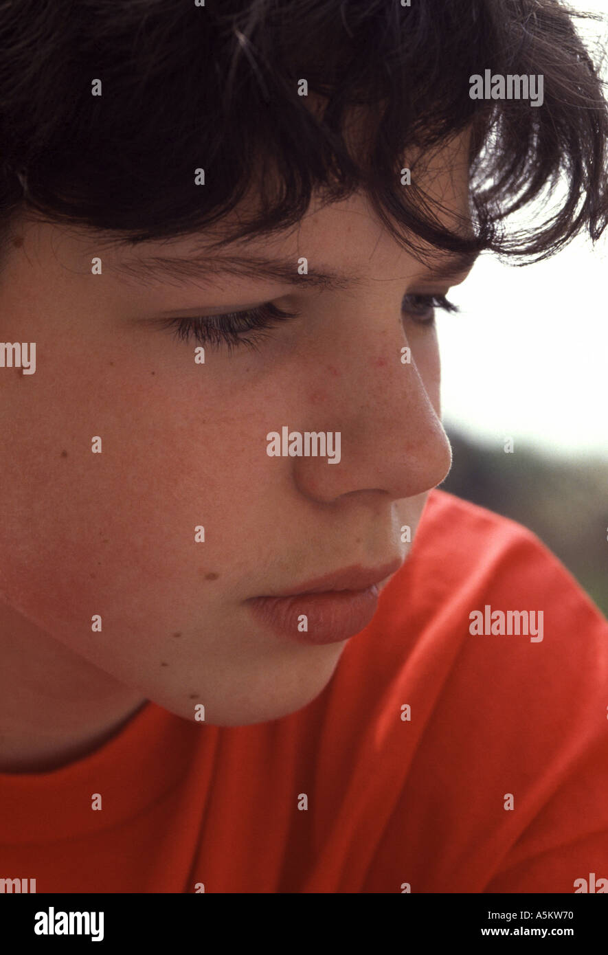 Portrait of a teenage boy looking wistful Stock Photo - Alamy