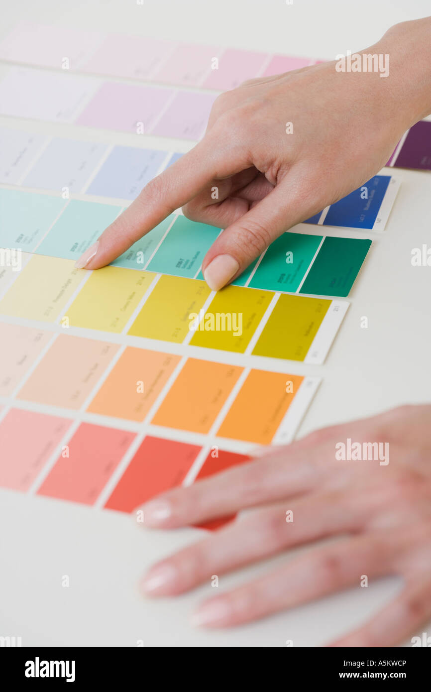 Close up of woman comparing paint swatches Stock Photo - Alamy