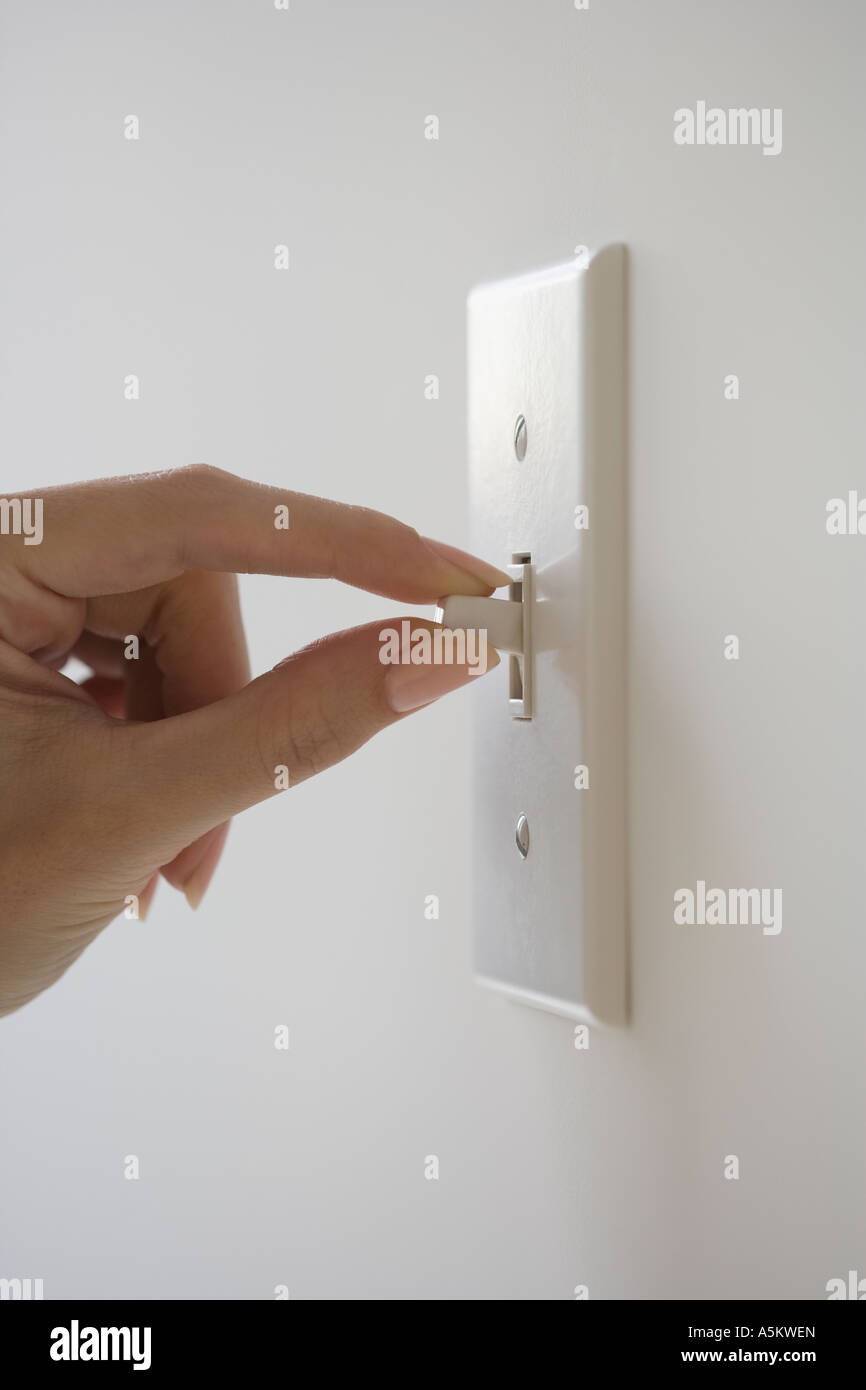 Close up of woman turning light switch Stock Photo - Alamy