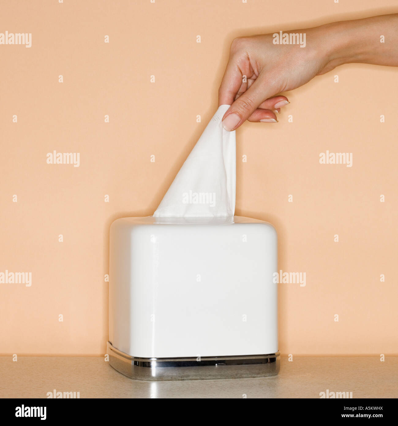 Woman pulling tissue out of box Stock Photo - Alamy