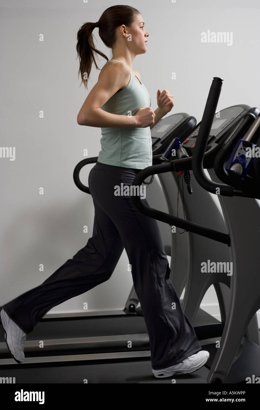 Woman running on treadmill at health club Stock Photo - Alamy