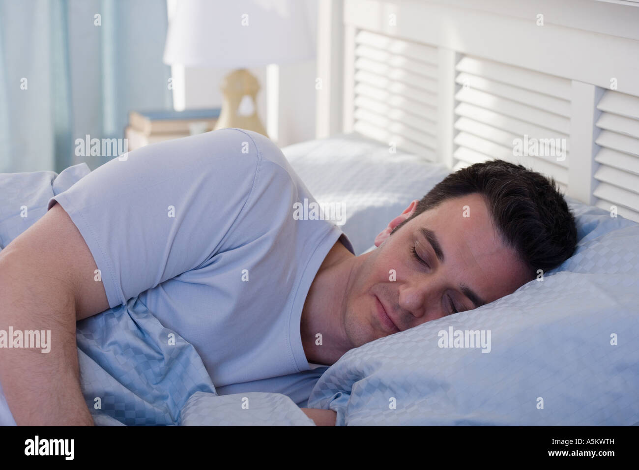 Man sleeping in bed Stock Photo - Alamy