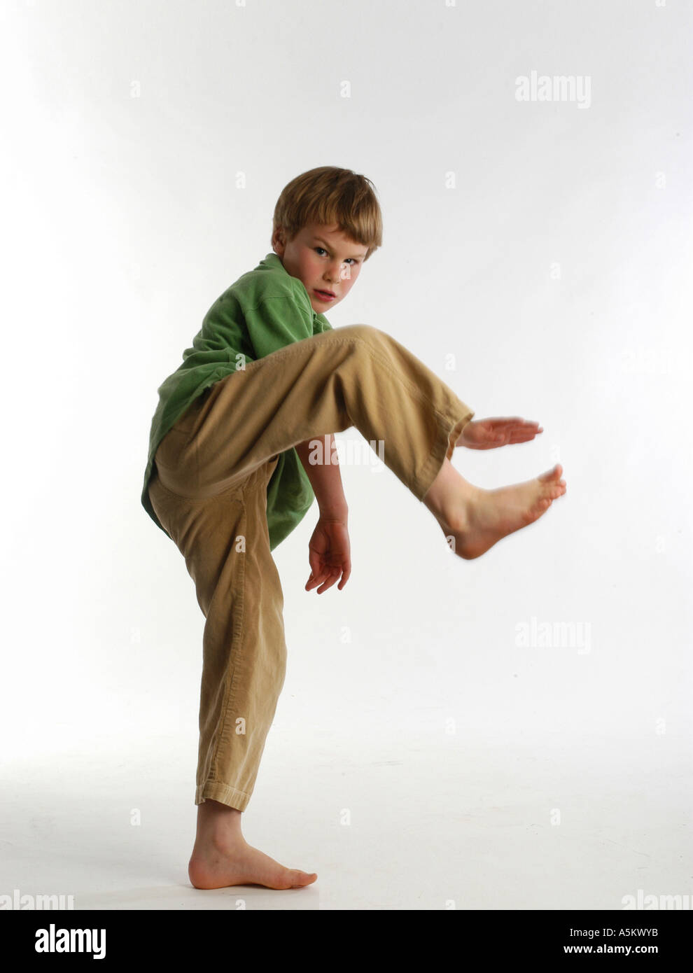 A young boy looks as though he is about to do a karate chop as he ...