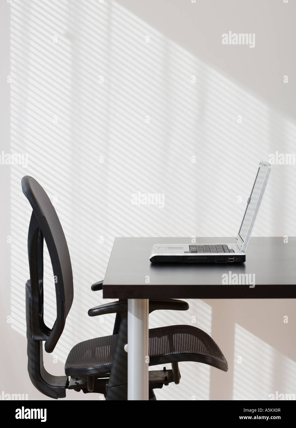 Empty desk with laptop Stock Photo - Alamy