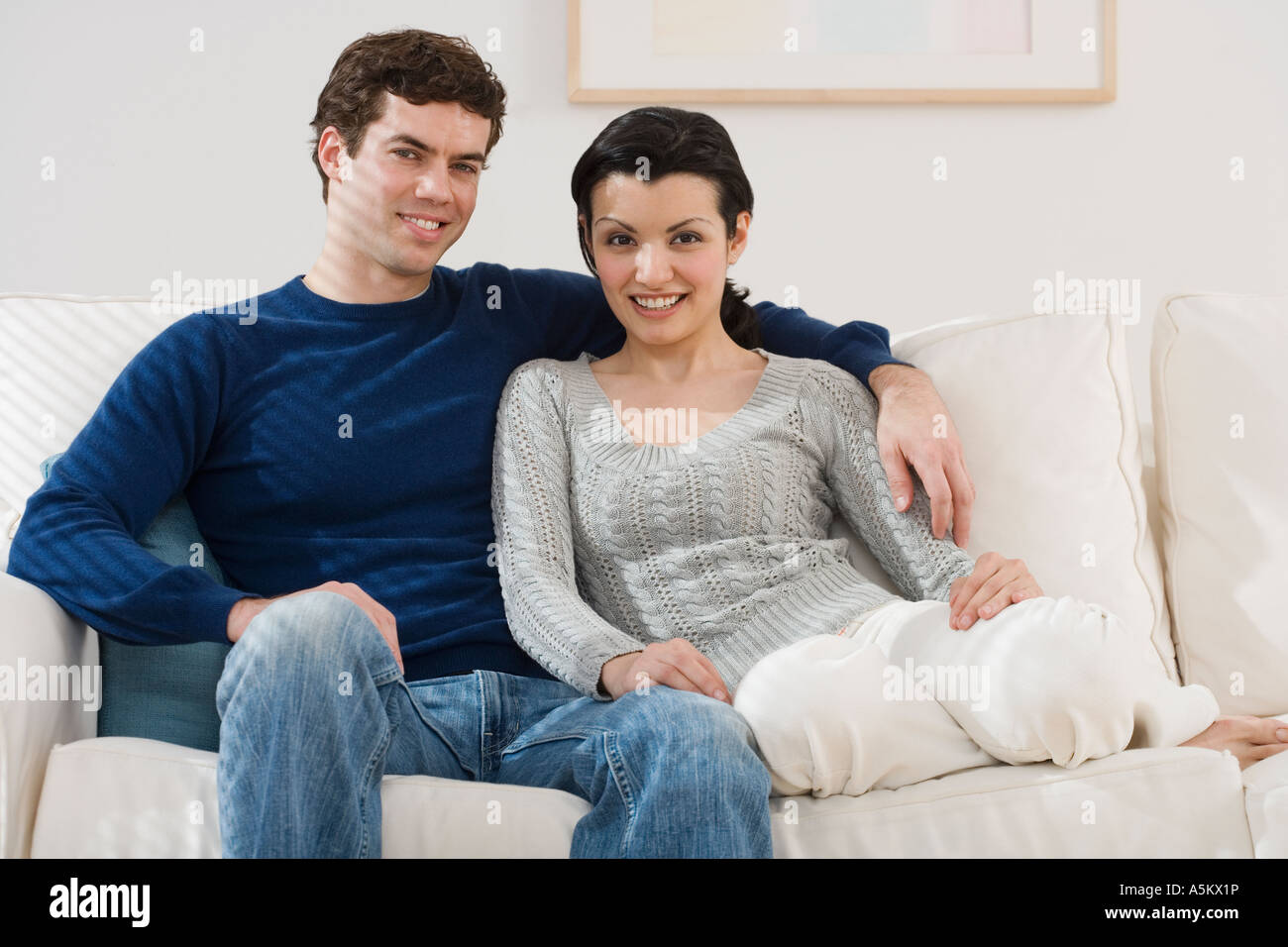 Portrait of couple on sofa Stock Photo - Alamy