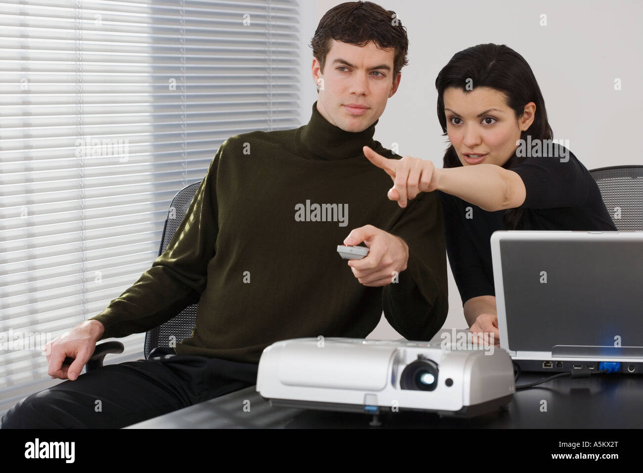 Businesspeople using projector Stock Photo - Alamy