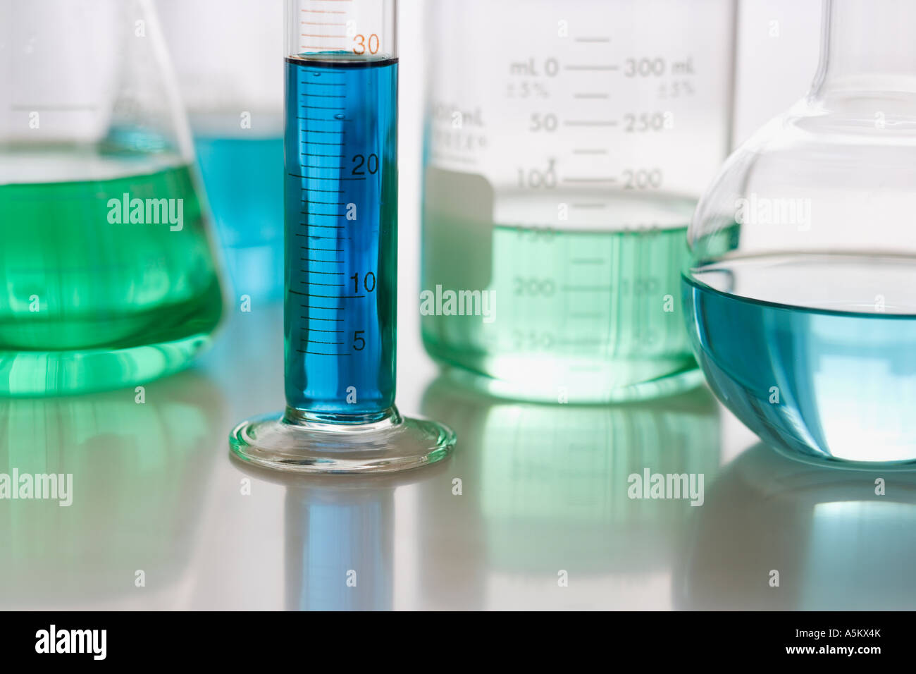 Close up of beakers with liquid Stock Photo - Alamy