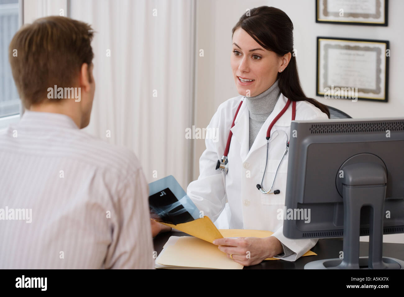 Female physician communicating male patient hi-res stock photography ...
