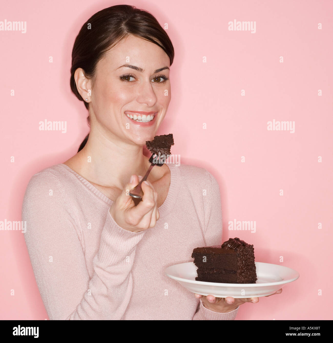 Portrait of woman eating cake Stock Photo - Alamy
