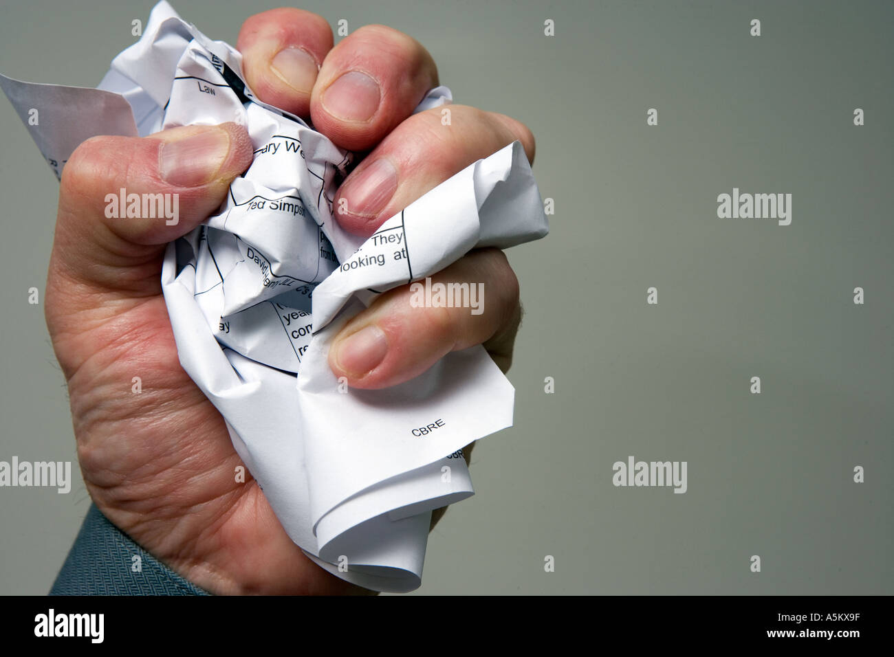 Stress office worker holds crumpled paper Stock Photo - Alamy